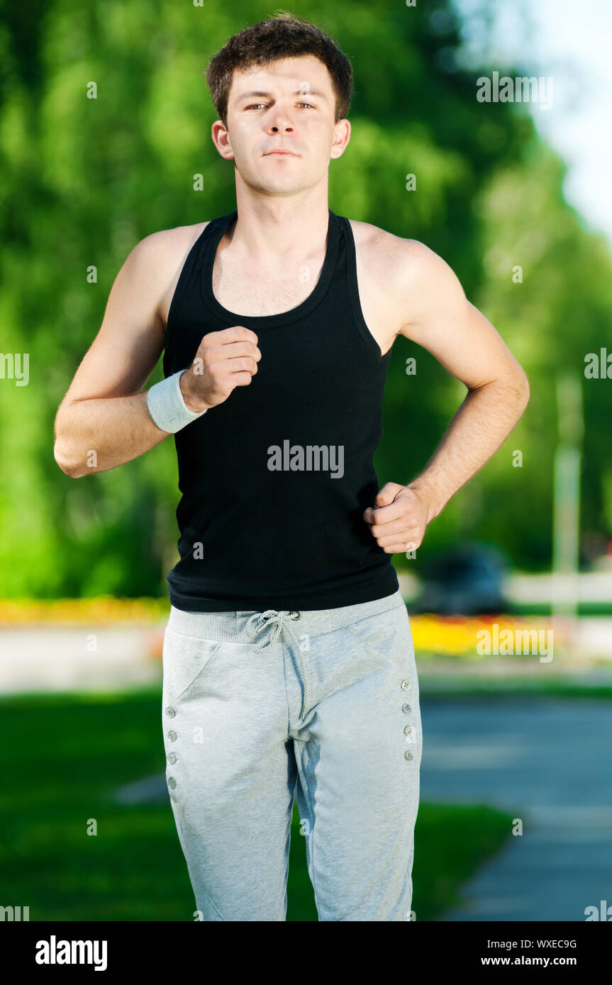 Young man jogging in park. Health and fitness Stock Photo - Alamy