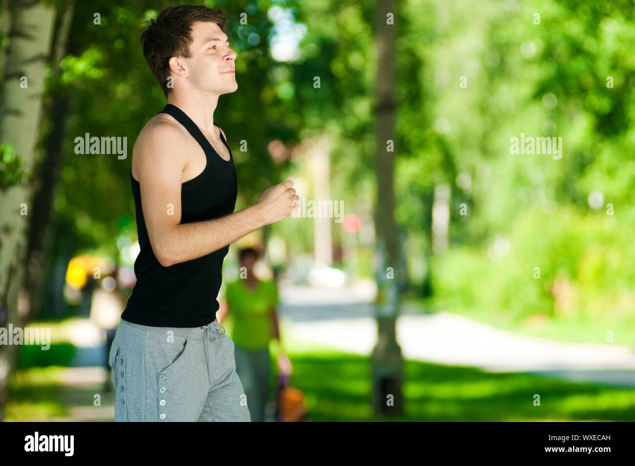 Young man jogging in park. Health and fitness Stock Photo - Alamy