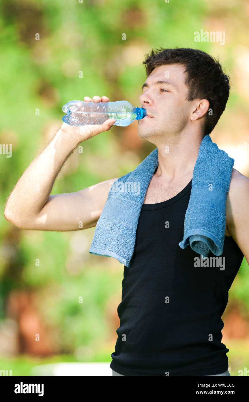 Man drinking water after fitness exercise Stock Photo - Alamy