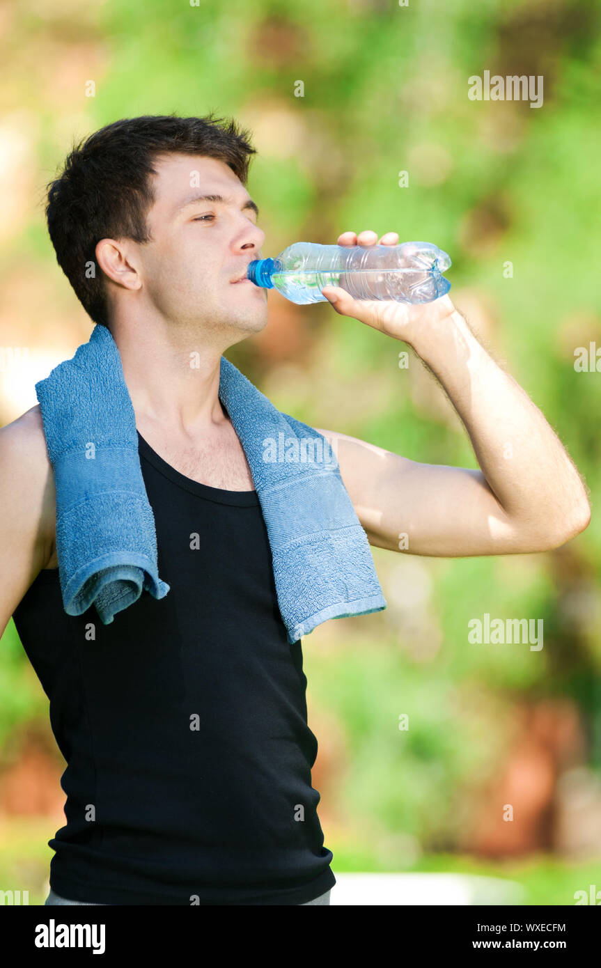 Man drinking water after fitness exercise Stock Photo - Alamy