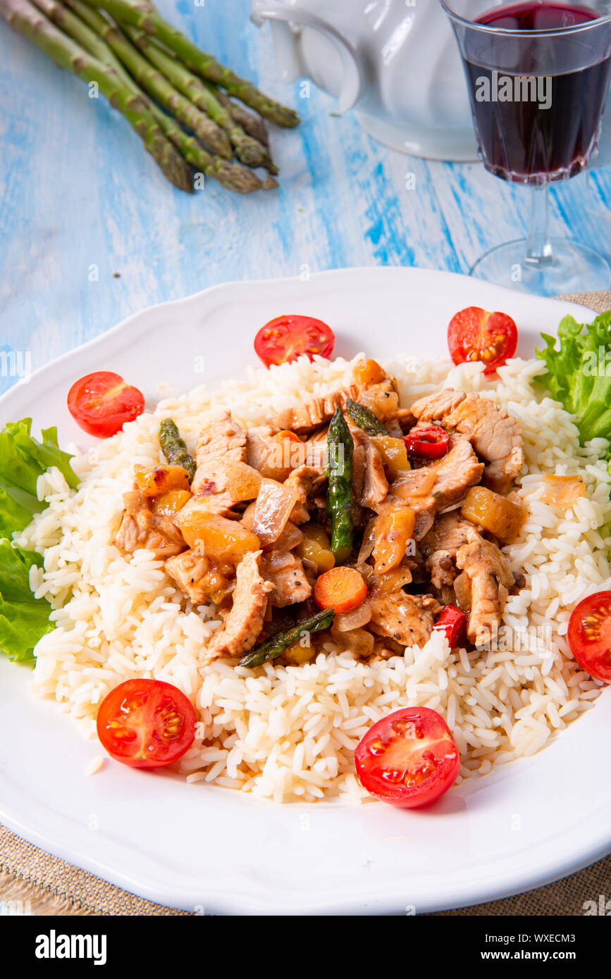 Turkey fricassee on rice with asparagus and paprika Stock Photo - Alamy