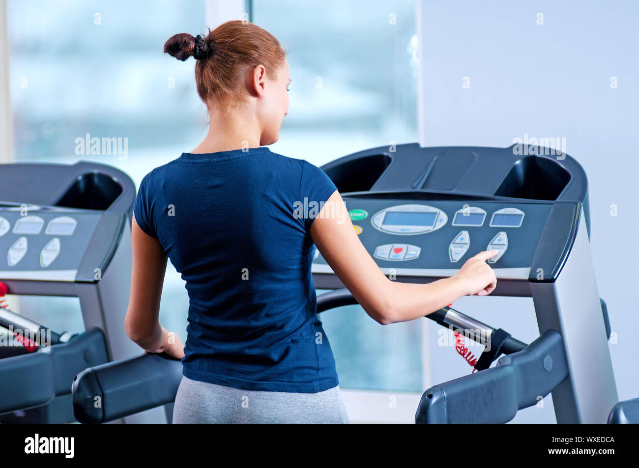 Young woman at the gym exerce. Jog on machine Stock Photo - Alamy