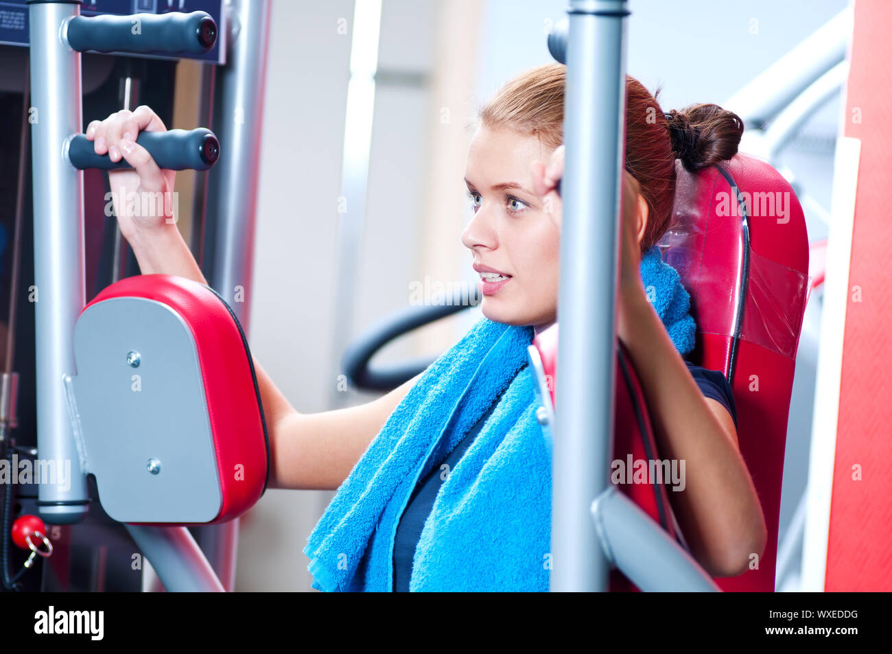 Woman at the gym exercising on a machine Stock Photo - Alamy