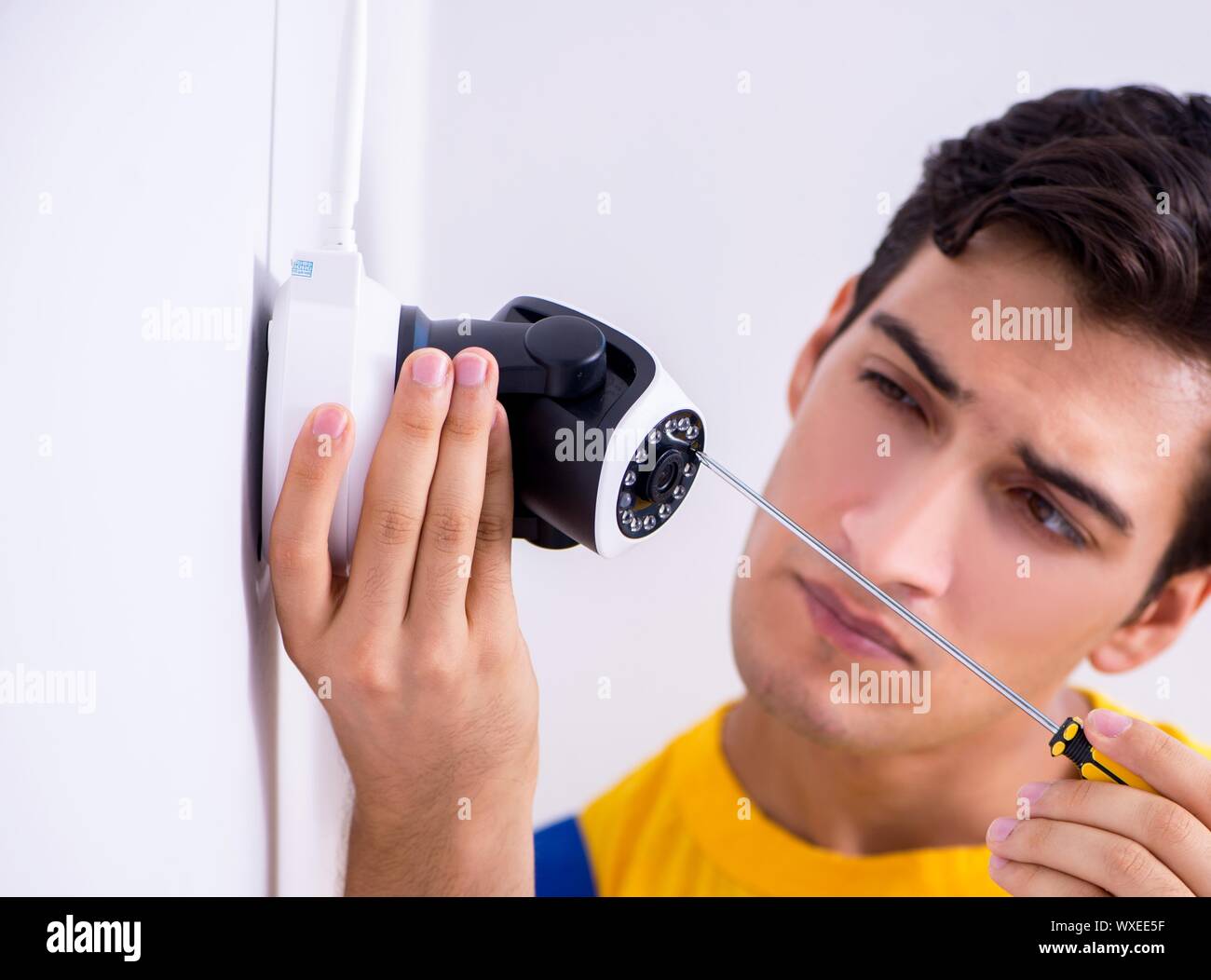 Security surveillance technician adjusting cctv hi-res stock ...