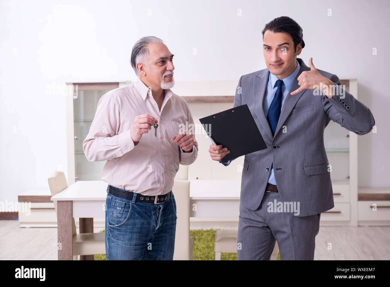 Male real estate agent and male client in the apartment Stock Photo - Alamy