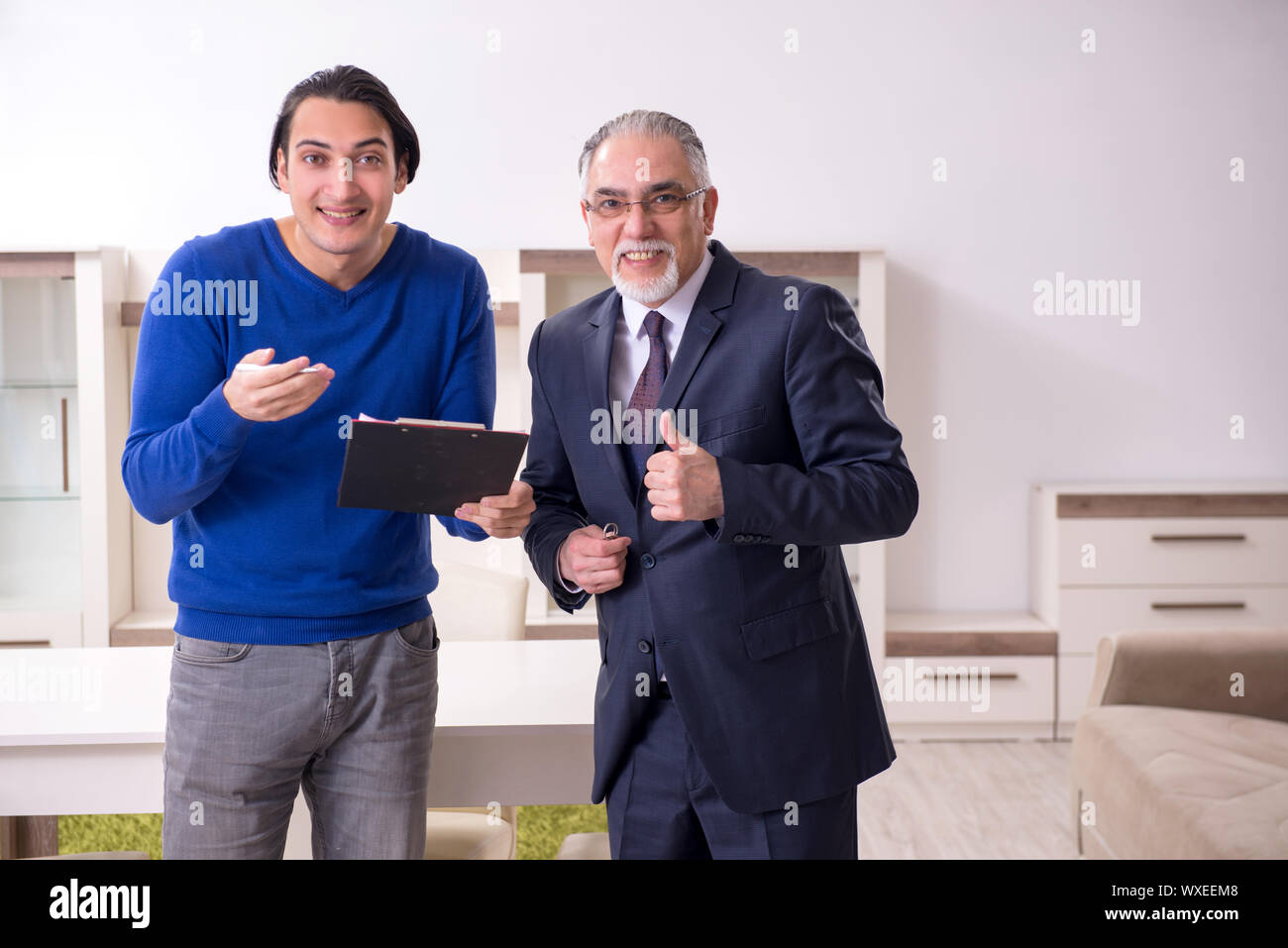 Male real estate agent and male client in the apartment Stock Photo - Alamy