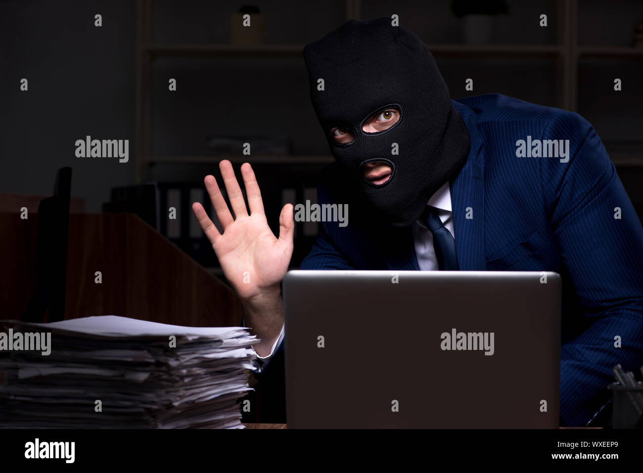 Male employee stealing information in the office night time Stock Photo ...