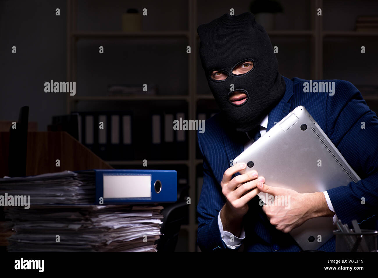 Male employee stealing information in the office night time Stock Photo ...