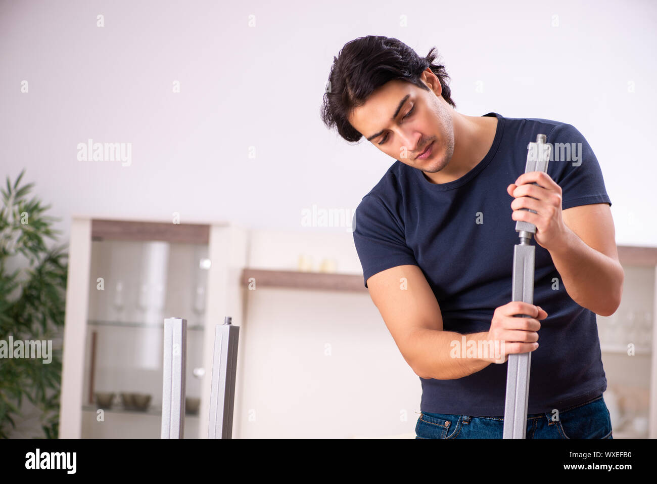 Male worker repairing table hi-res stock photography and images - Alamy