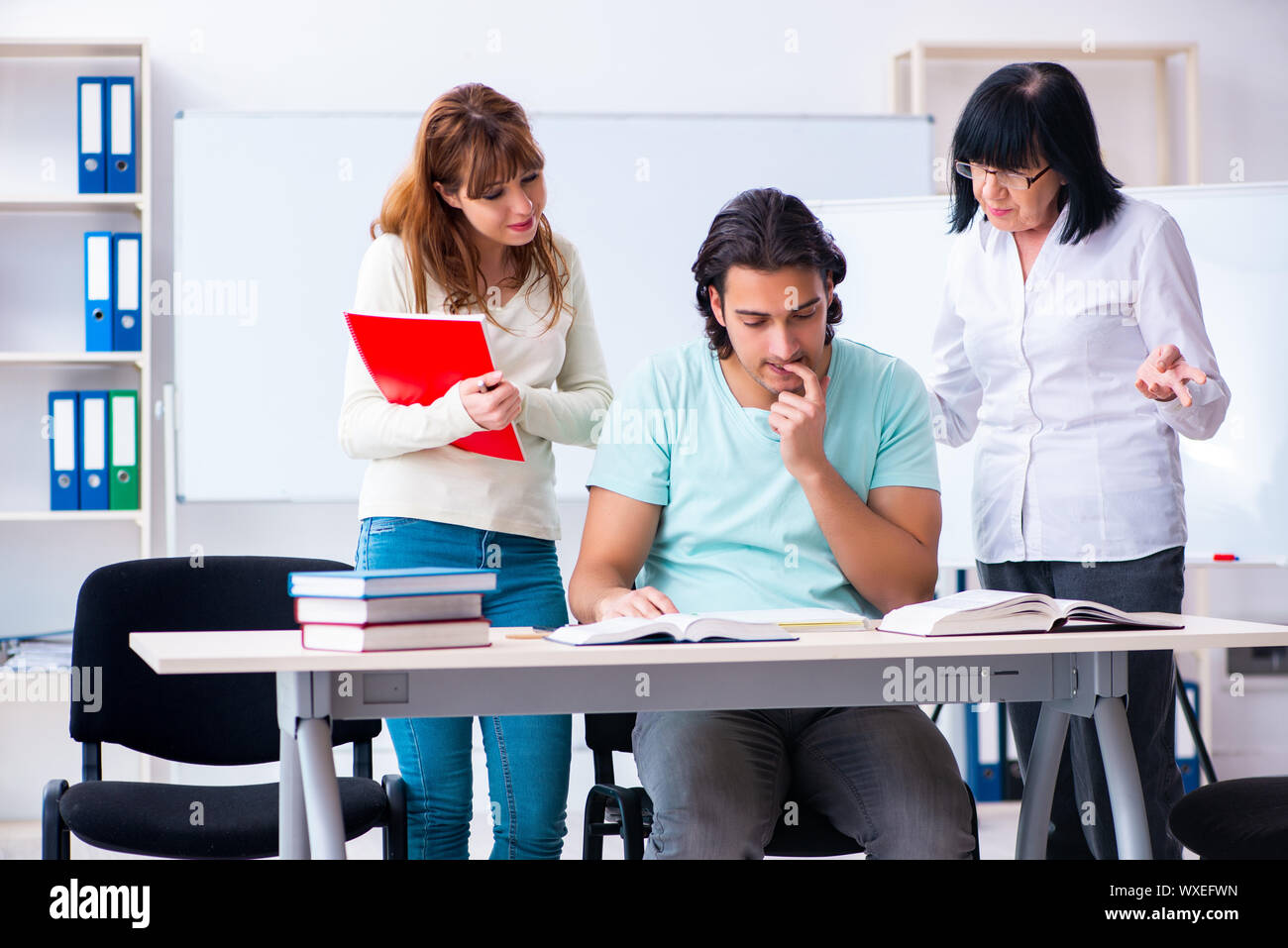 Old teacher and students in the classroom Stock Photo - Alamy