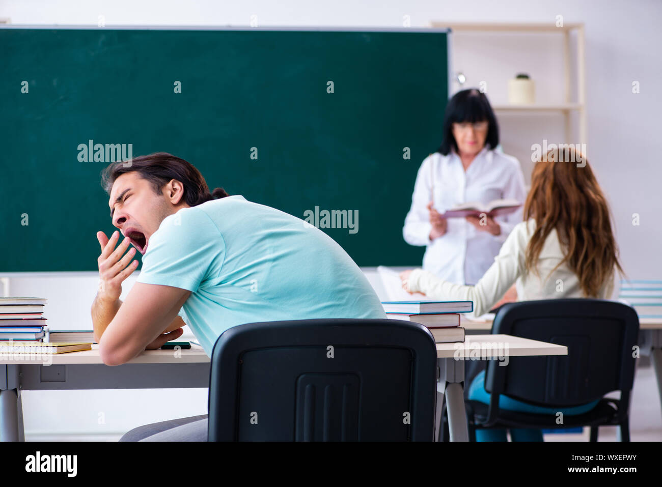 Old teacher and students in the classroom Stock Photo - Alamy