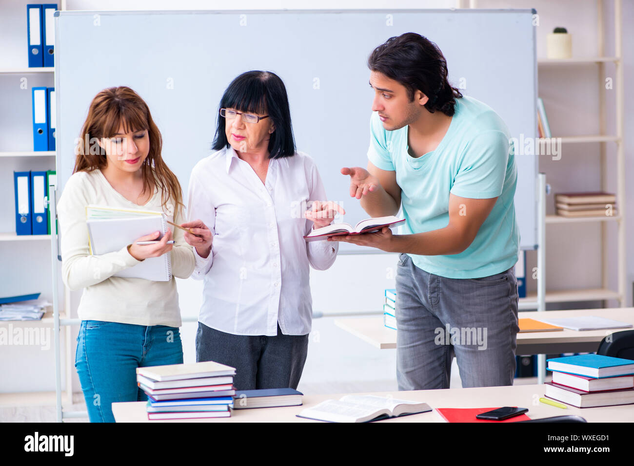 Old teacher and students in the classroom Stock Photo - Alamy