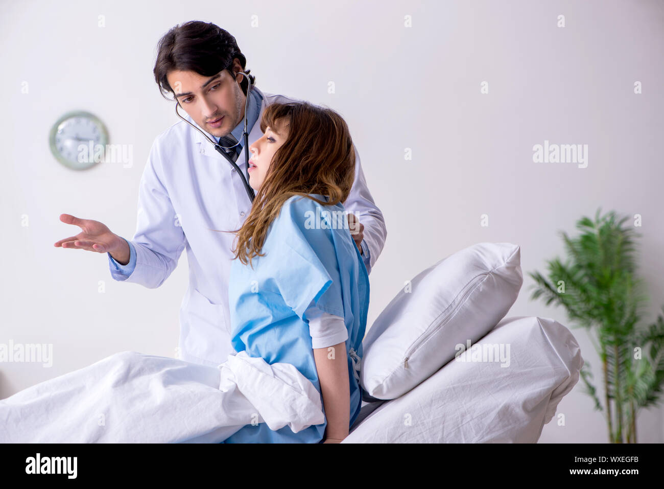 Male doctor visiting female patient in ward Stock Photo - Alamy