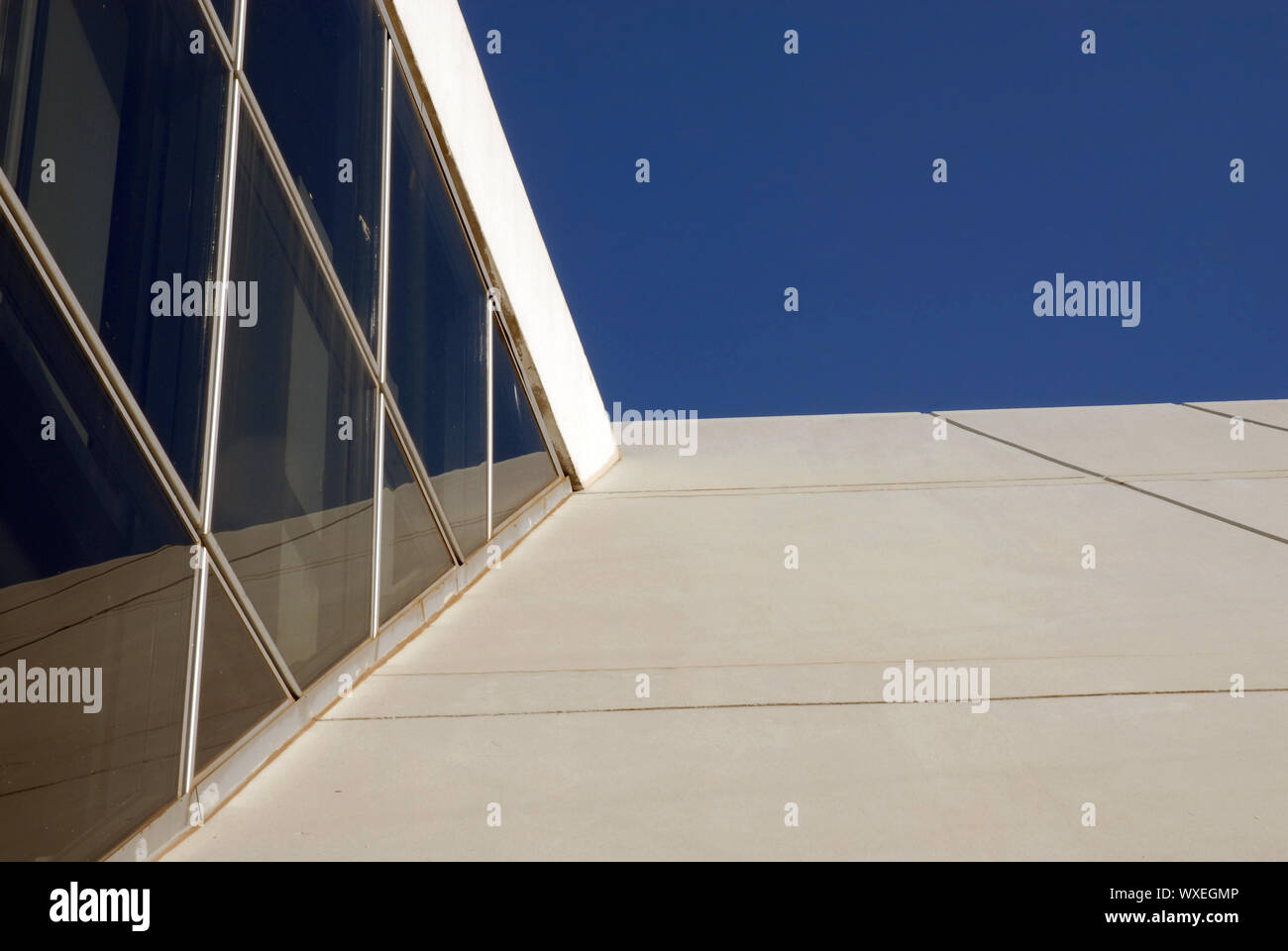 Architectural detail of a contemporary building reflecting on a blue ...