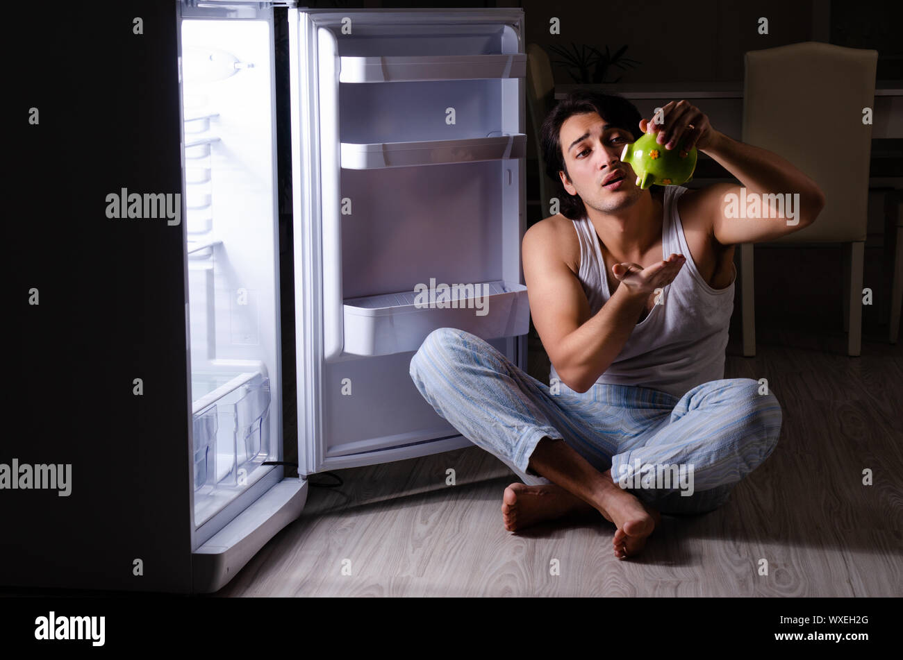 Man eating out of fridge hi-res stock photography and images - Alamy