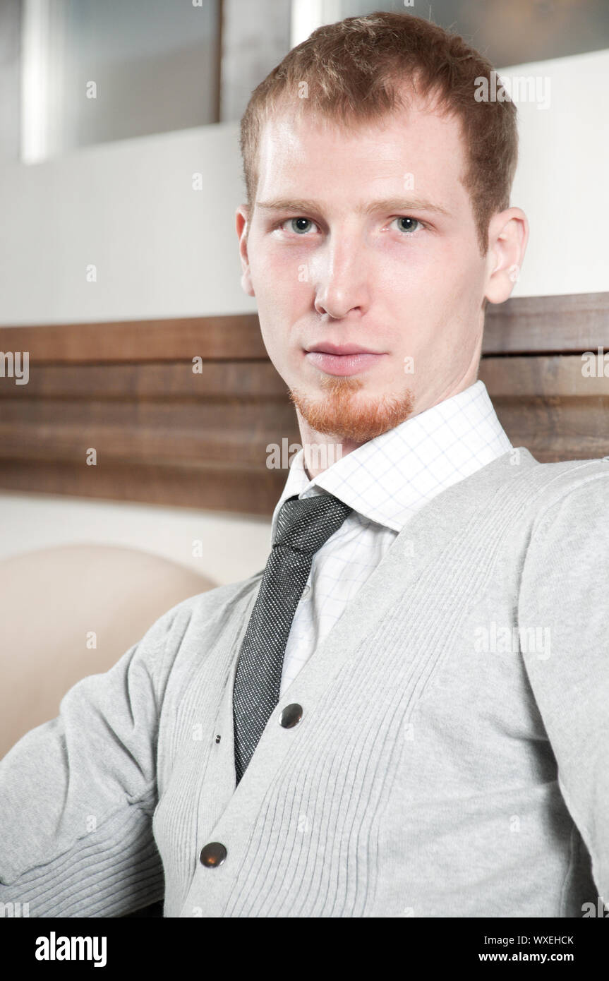Sure young business man in office rest room interior Stock Photo - Alamy