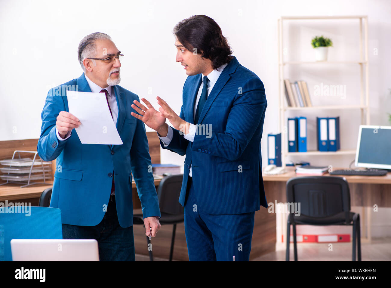 Young and old employees working together in the office Stock Photo - Alamy