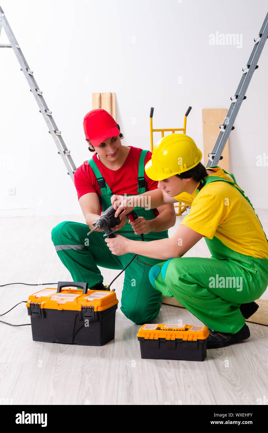 Two workers contractors working indoors Stock Photo - Alamy