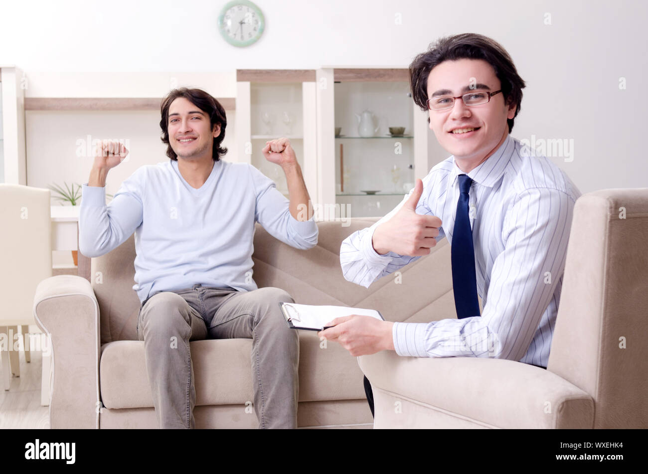 Young male patient discussing with psychologist personal problem Stock ...