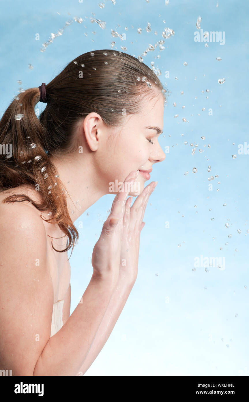 Close-up portrait of beautiful emotional woman washing her face Stock ...