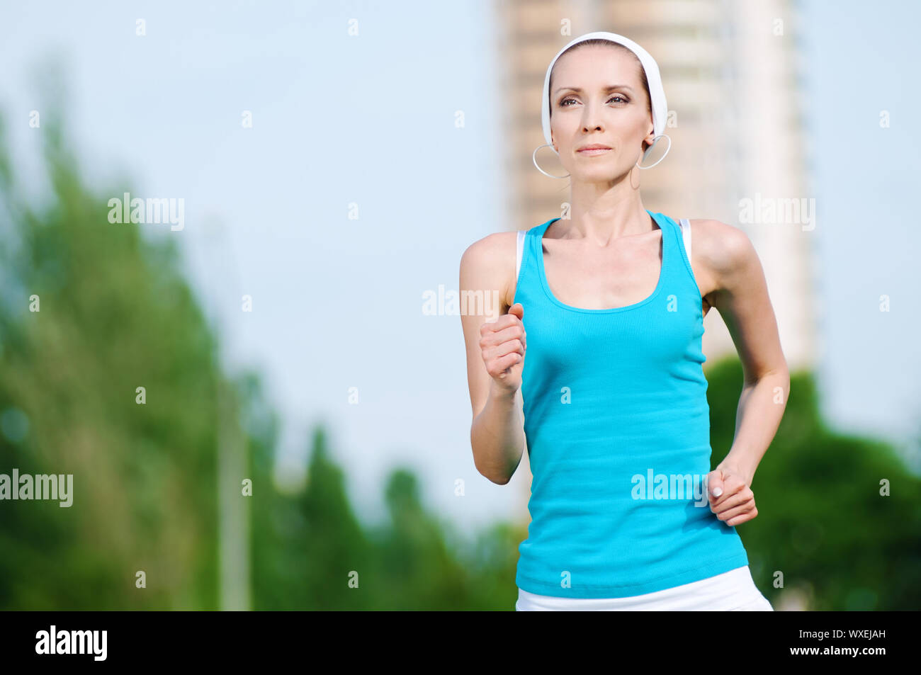 Beautiful woman running in green park on sunny summer day Stock Photo ...