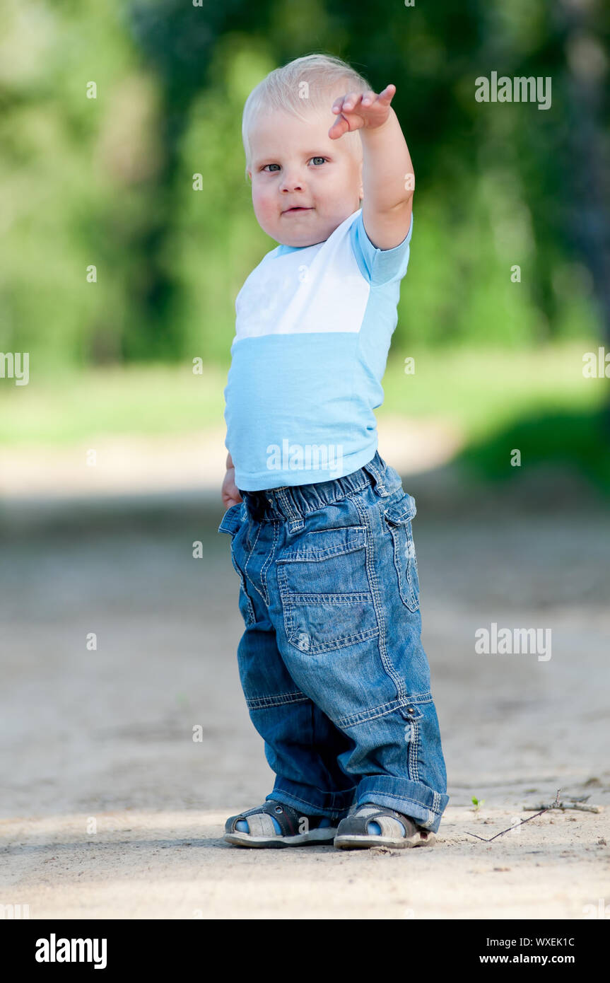Portrait of a happy little boy in the green nature park. Outdoor Stock ...