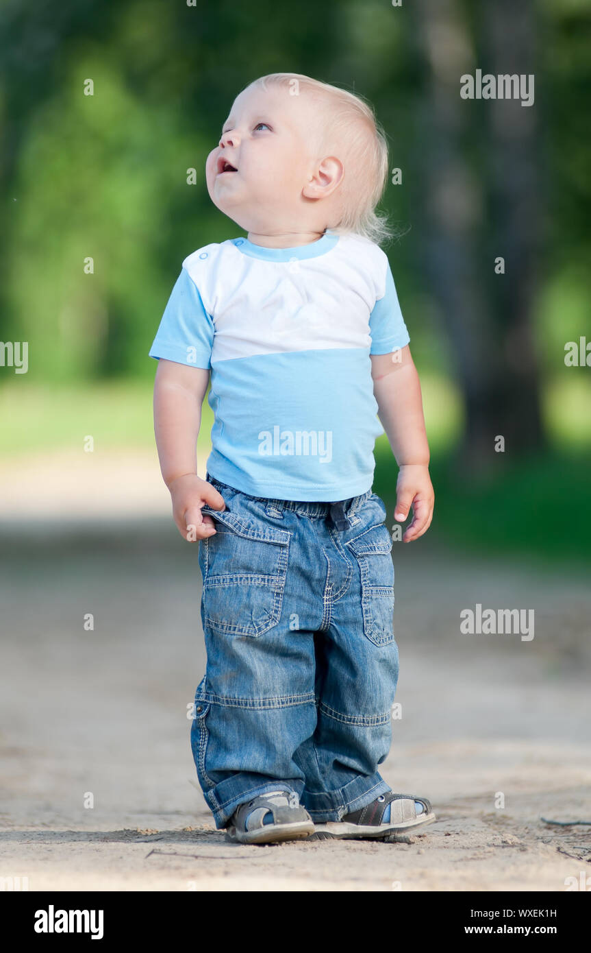 Portrait of a happy little boy in the green nature park. Outdoor Stock ...