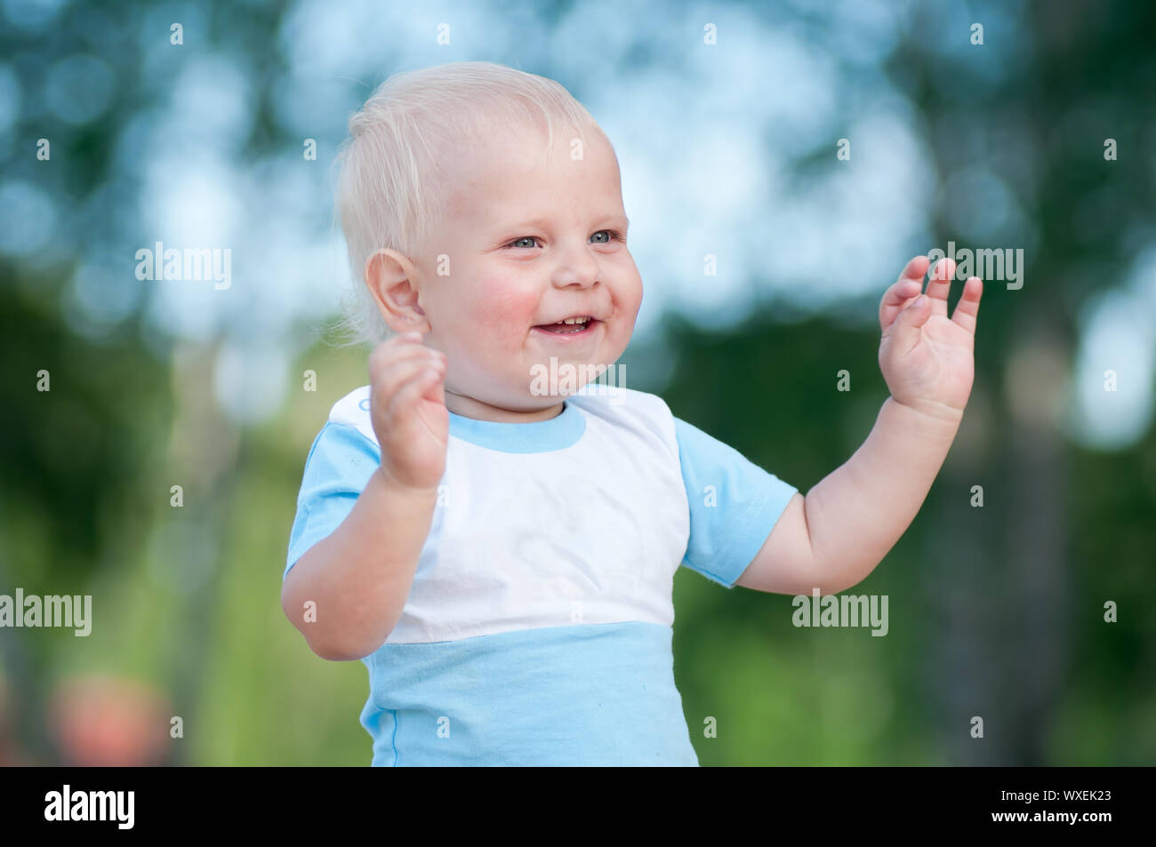 Portrait of a happy little boy in the green nature park. Outdoor Stock ...