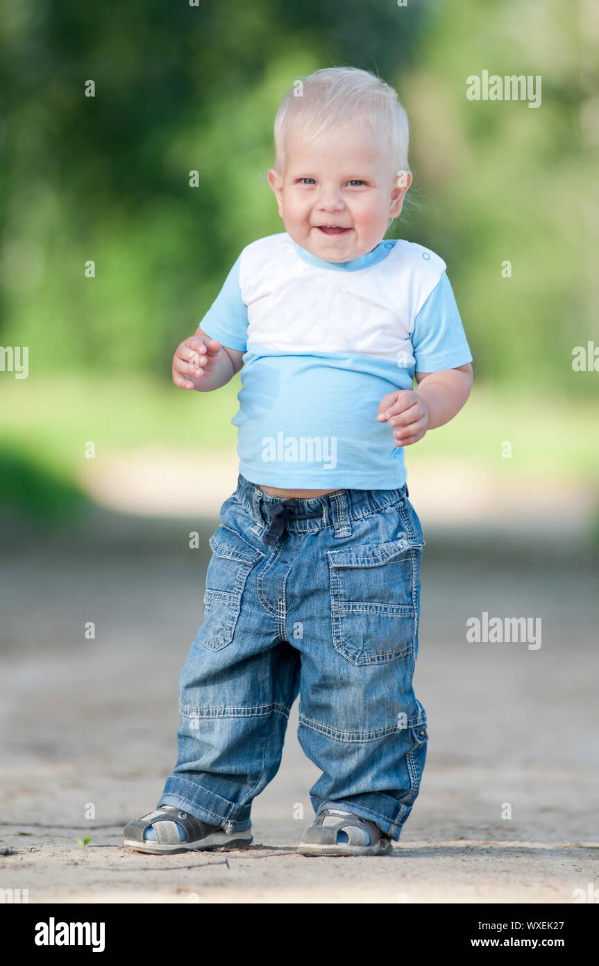 Portrait of a happy little boy in the green nature park. Outdoor Stock ...
