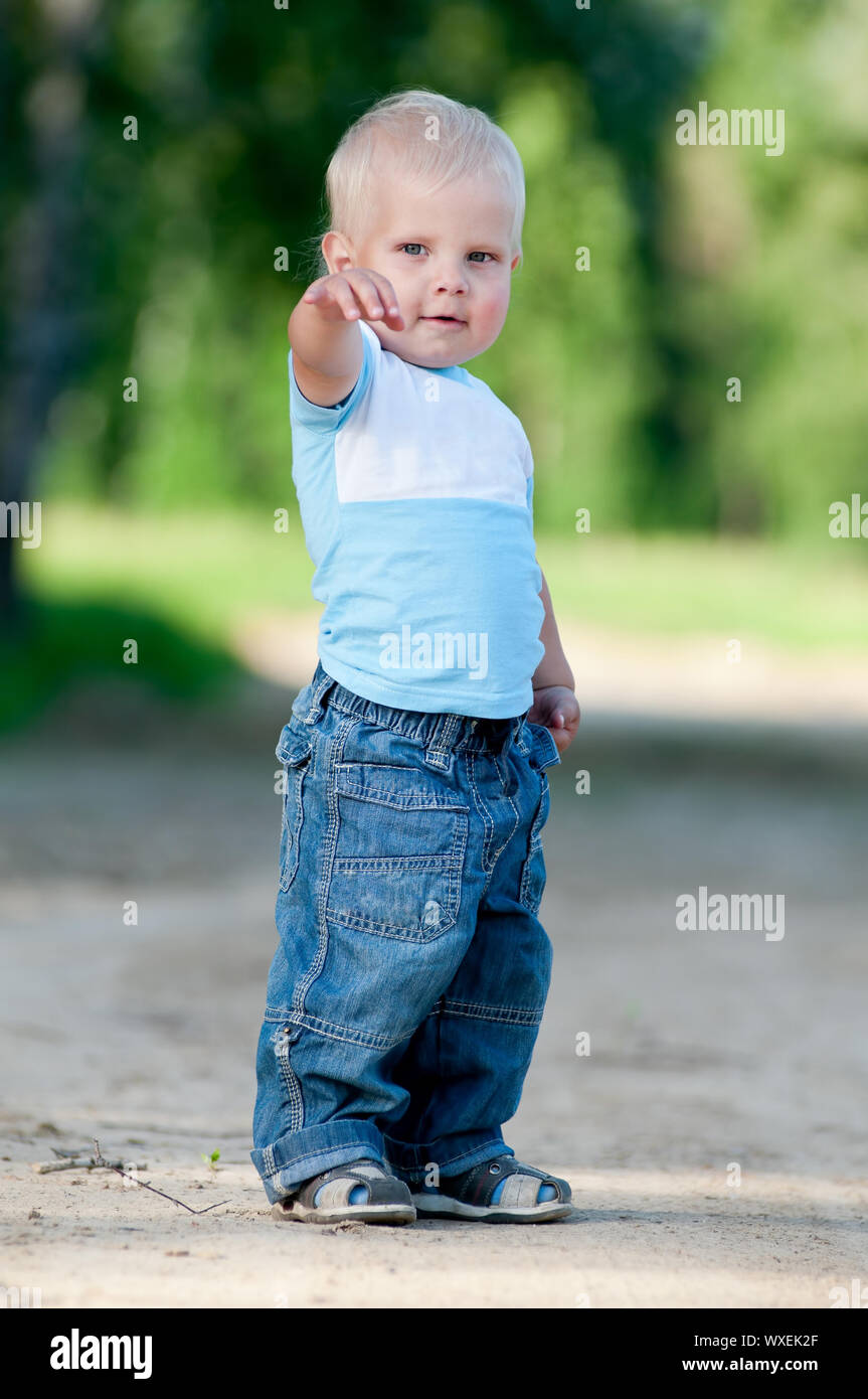 Portrait of a happy little boy in the green nature park. Outdoor Stock ...