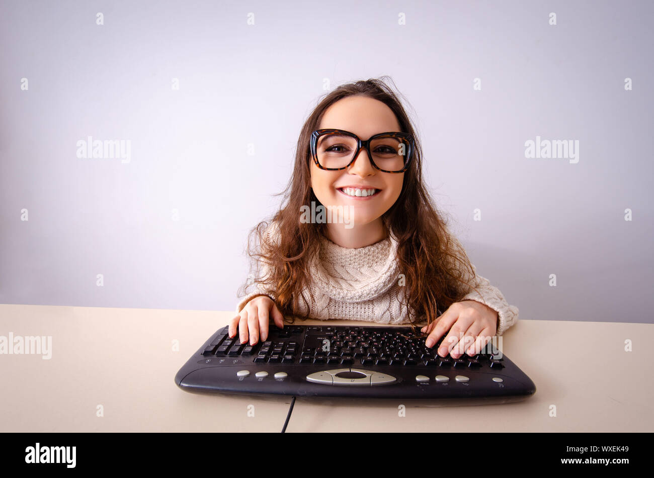Funny nerd girl working on computer Stock Photo - Alamy