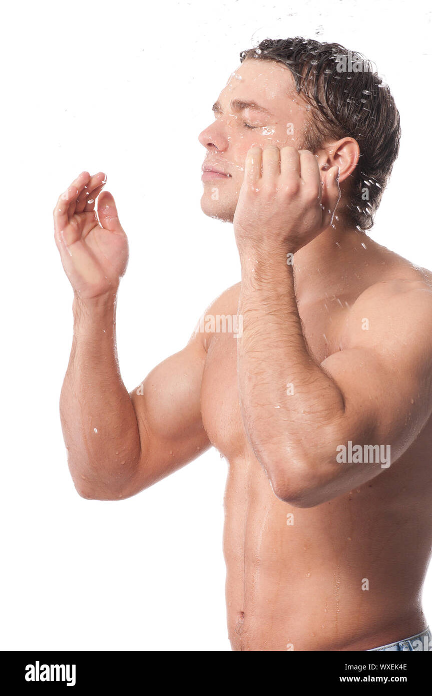 Young man wash face. Water drop and spash Stock Photo - Alamy
