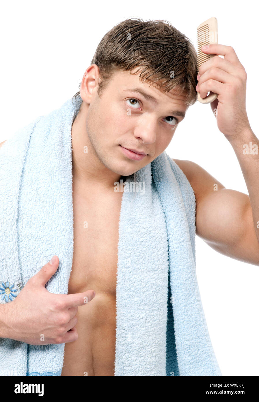 Young man combing his hair. Isolated on white Stock Photo - Alamy