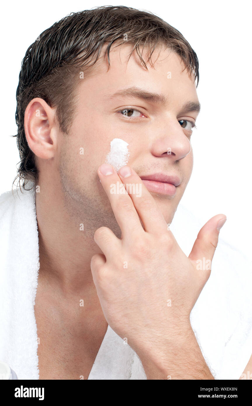 Man putting on cream lotion on face Stock Photo - Alamy