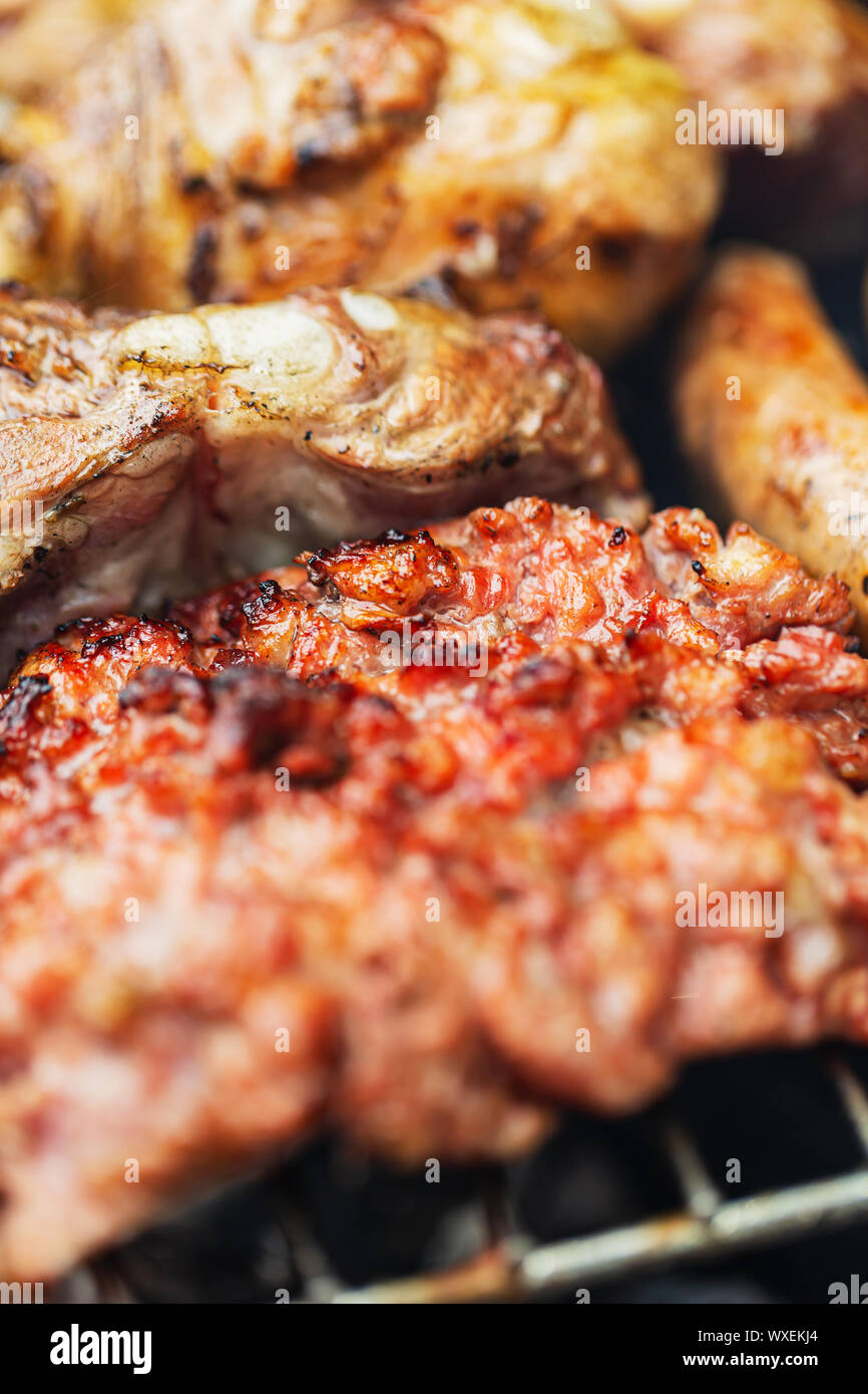 Barbeque grill mixed meat cooking on open air Stock Photo - Alamy