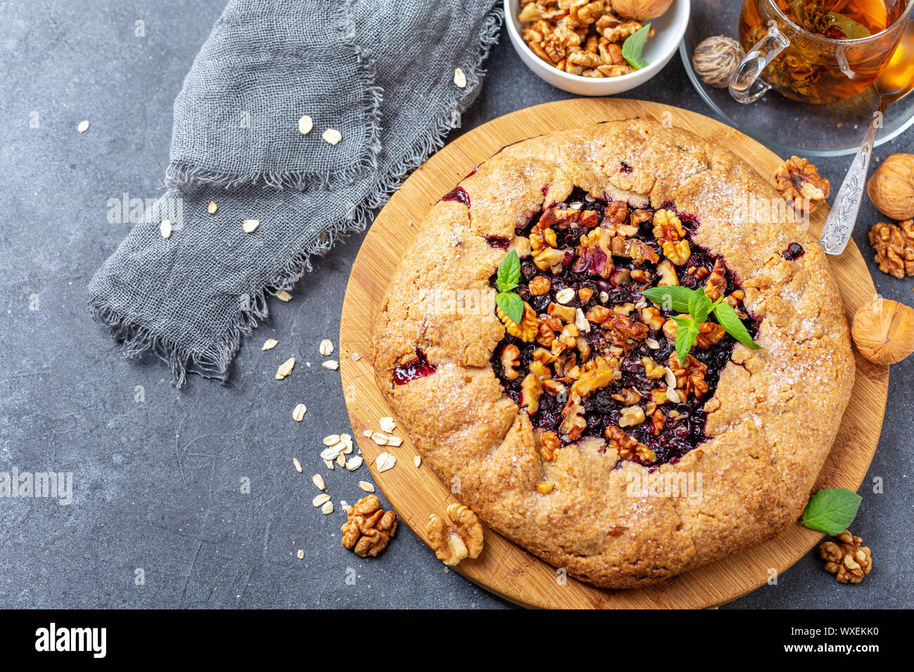 Galette pie with oat flakes, currant and walnuts Stock Photo - Alamy