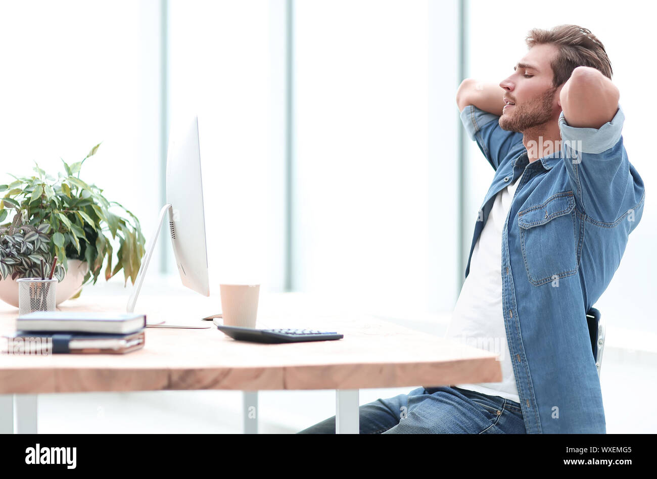 young businessman, looking carefully at the screen of his computer ...