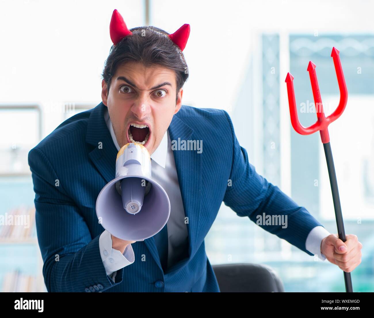 Devil angry businessman in the office Stock Photo - Alamy