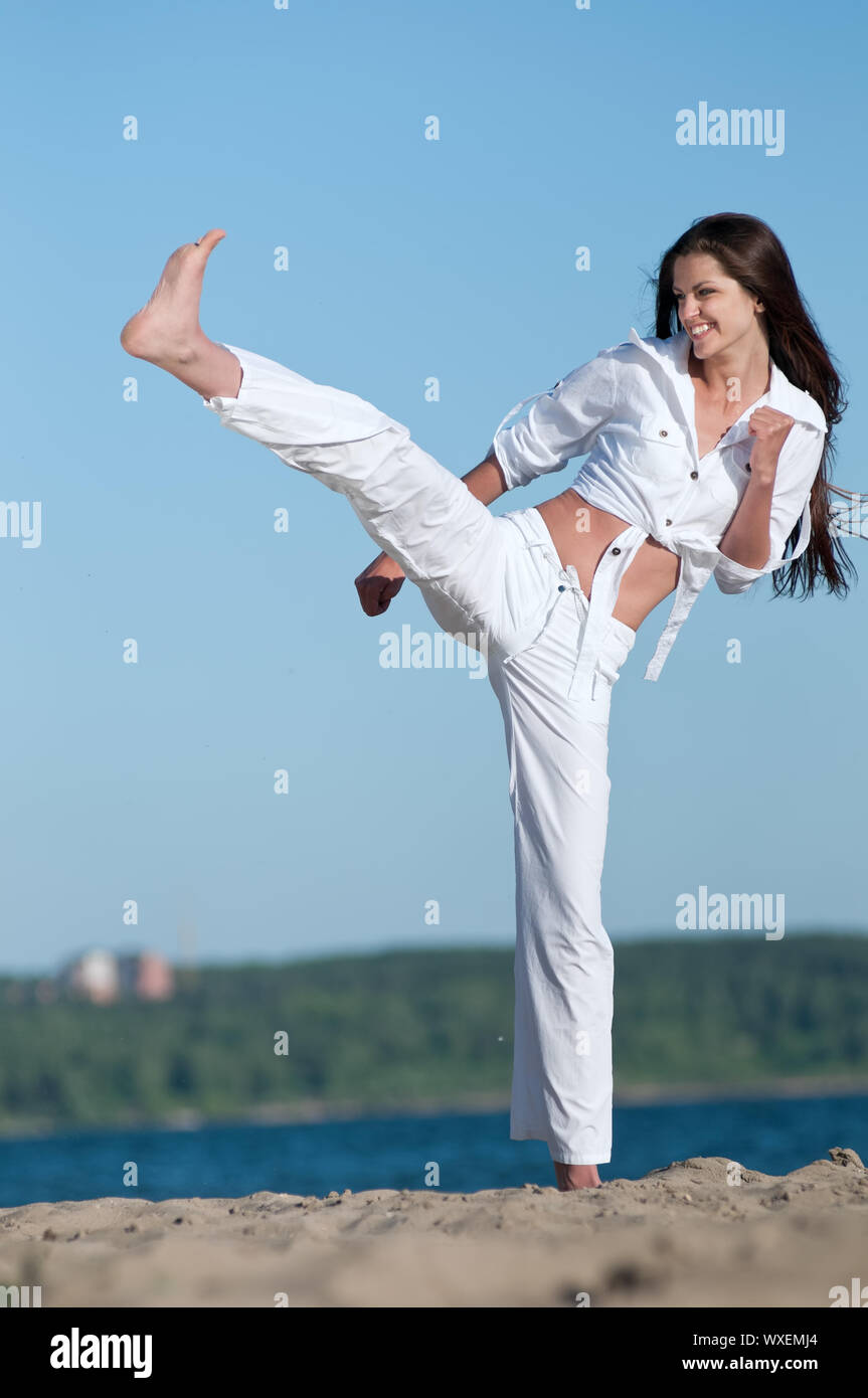 Athletic woman training high kick hi-res stock photography and images ...