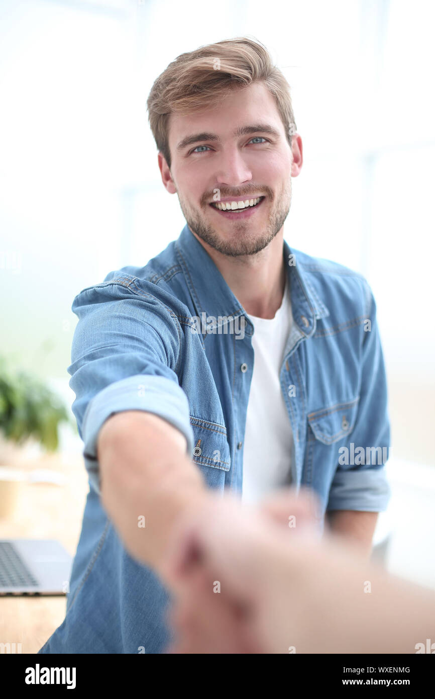 confident young man holding out his hand for a handshake Stock Photo ...