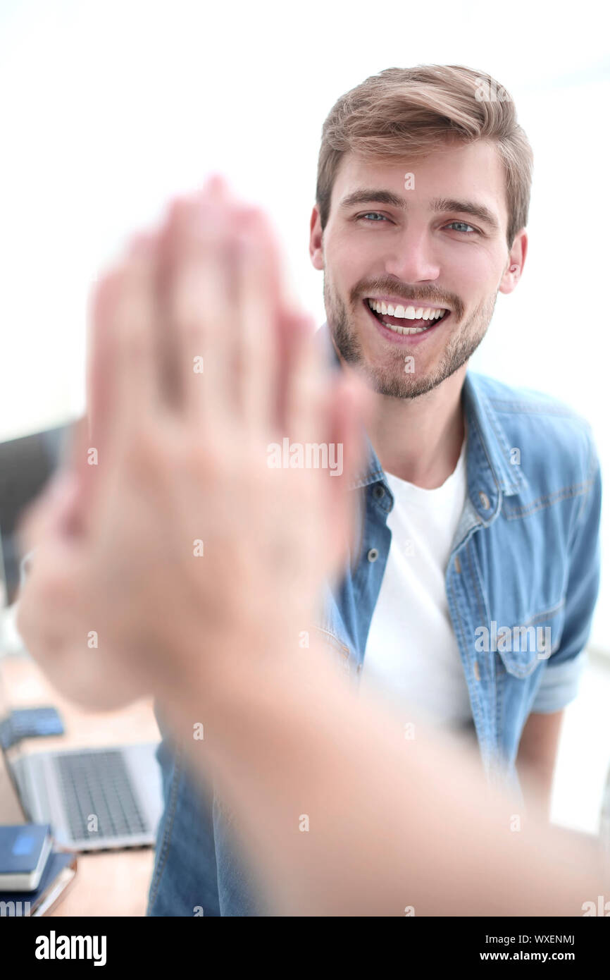 close up. smiling young man giving high five Stock Photo - Alamy
