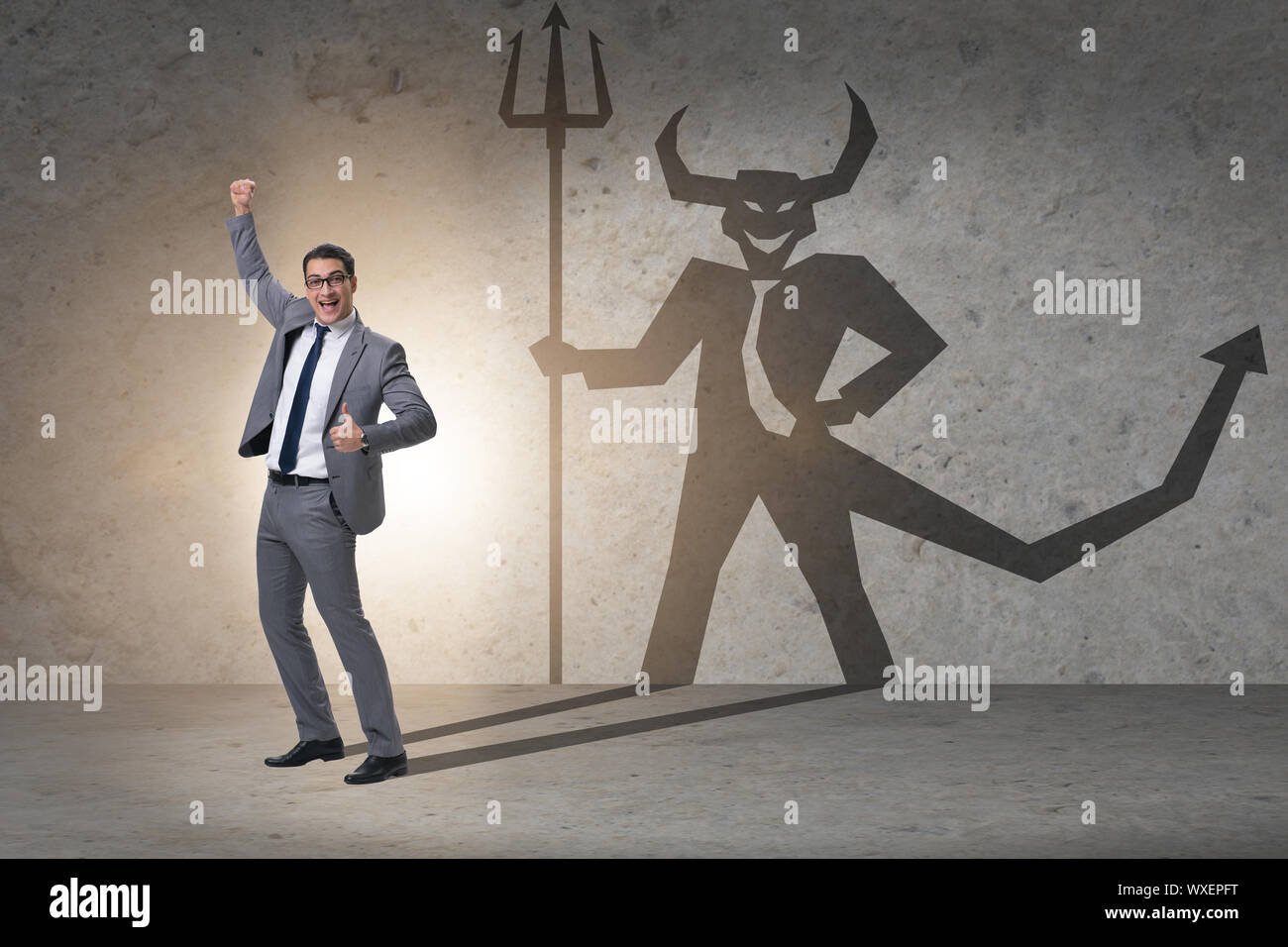 Devil hiding in the businessman - alter ego concept Stock Photo - Alamy