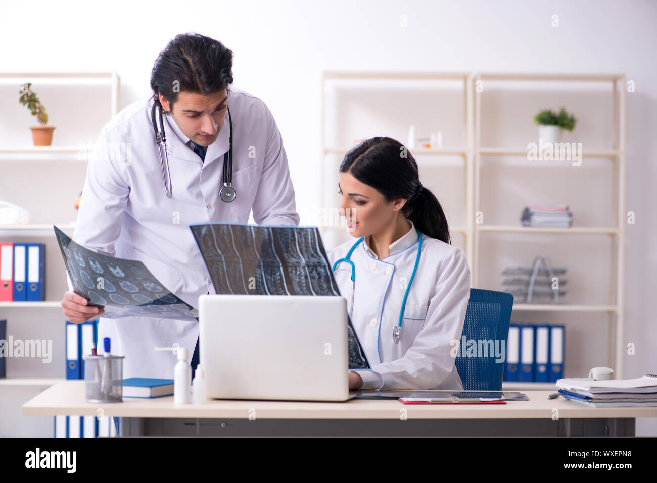 Two young doctors working in the clinic Stock Photo - Alamy