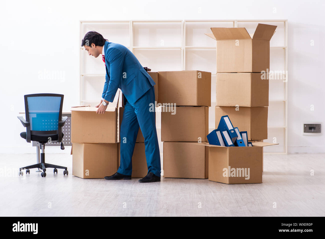 Young handsome businessman moving to new workplace Stock Photo - Alamy