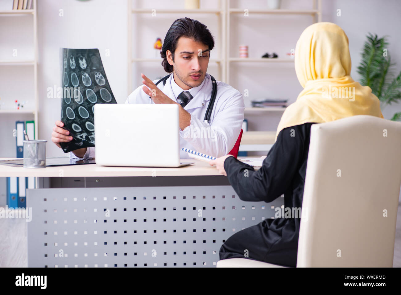 Female arab patient visiting male doctor Stock Photo - Alamy