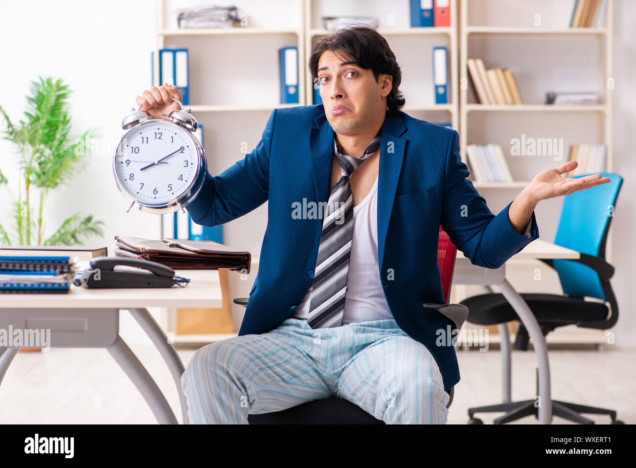 Employee coming to work straight from bed Stock Photo - Alamy
