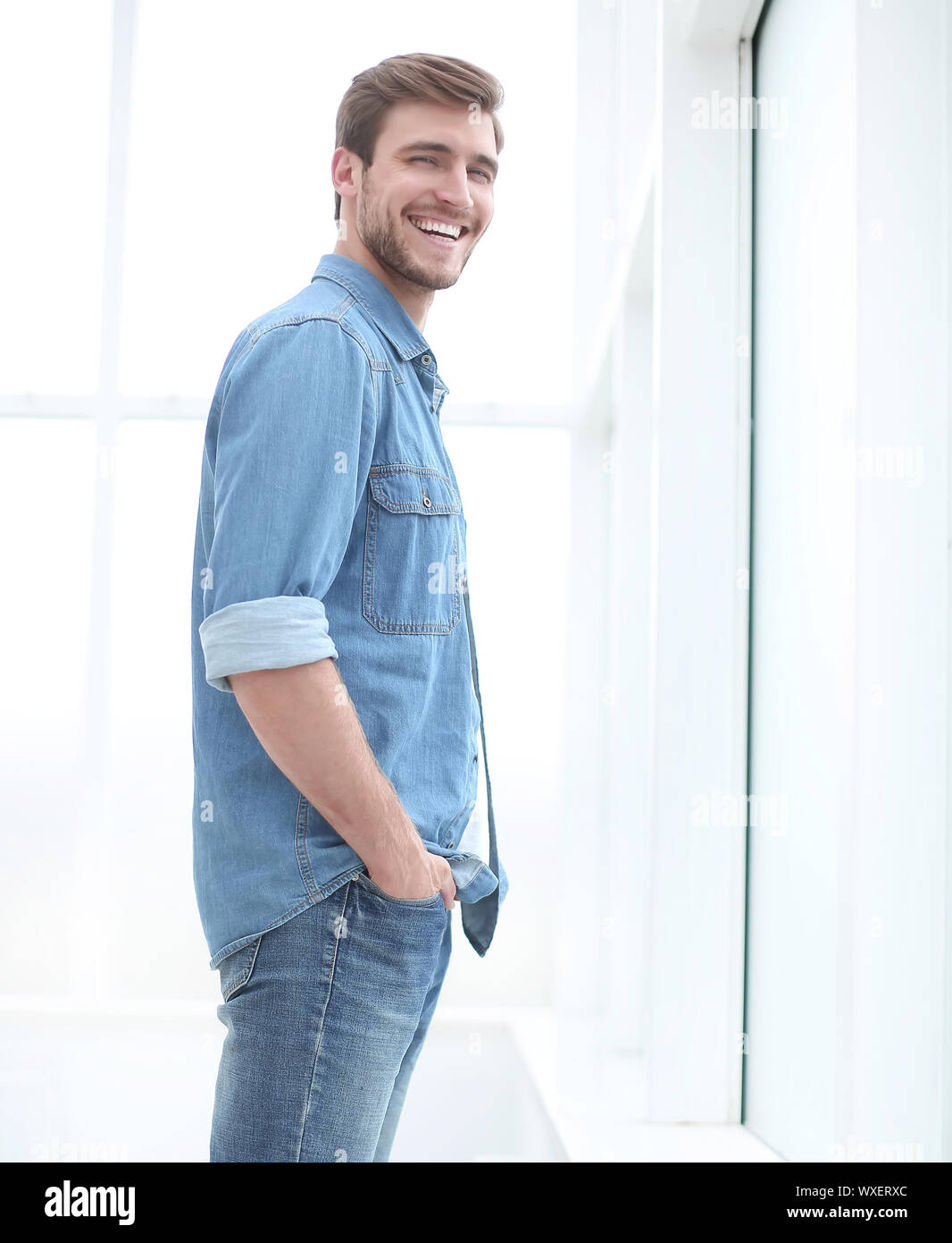 pensive young businessman looking through office window Stock Photo - Alamy pensive young businessman looking through office window Stock Photo - Alamy