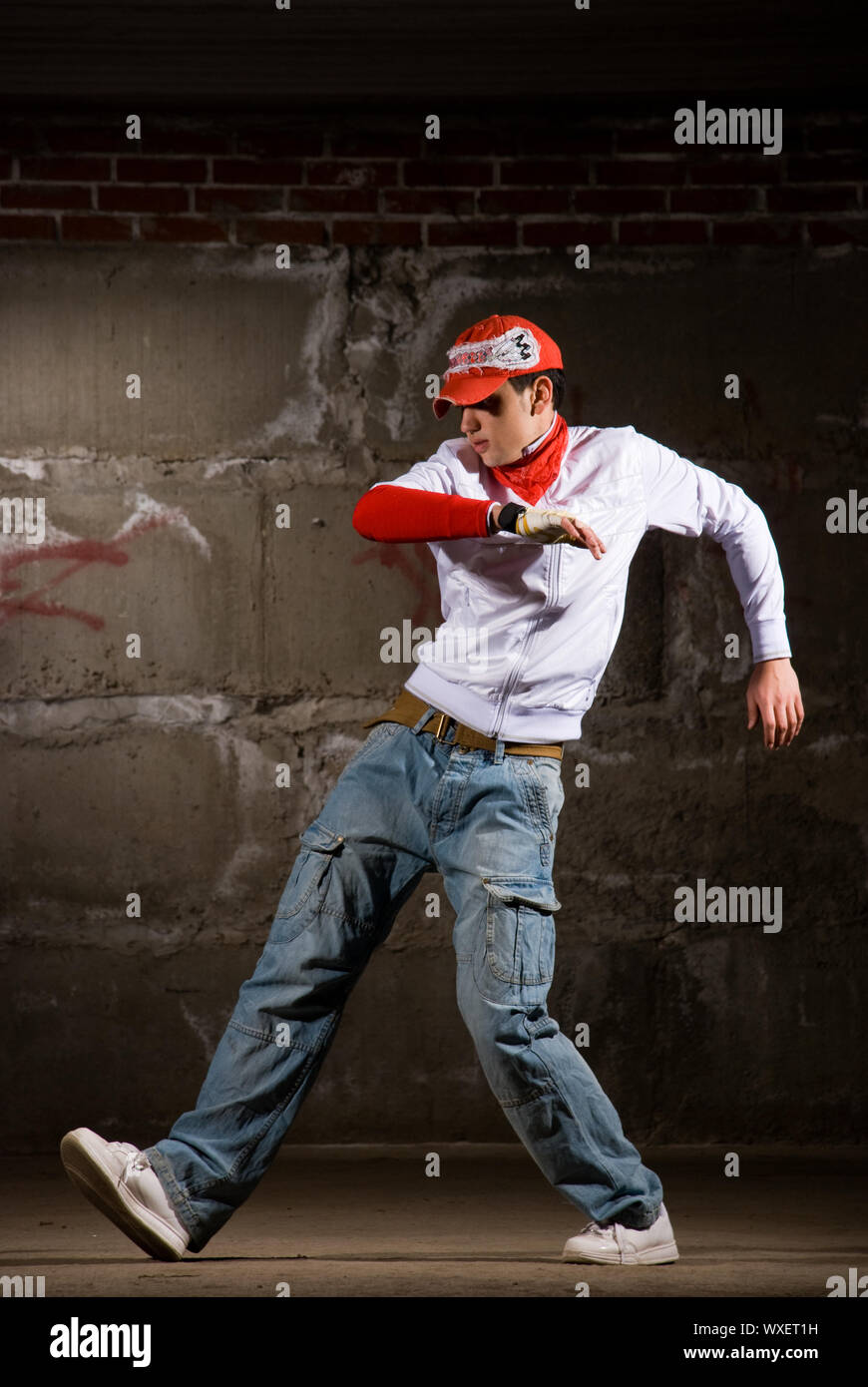 Hip hop men dancing in modern style over grey brick wall Stock Photo ...