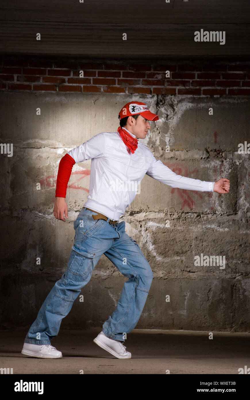 Hip hop men dancing in modern style over grey brick wall Stock Photo ...