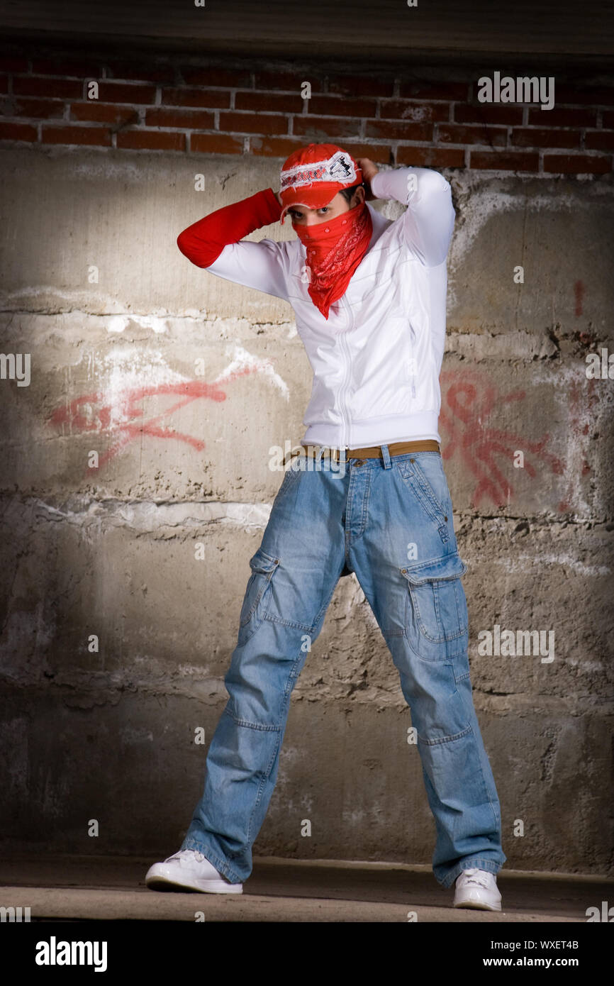 Hip hop men dancing in modern style over grey brick wall Stock Photo ...